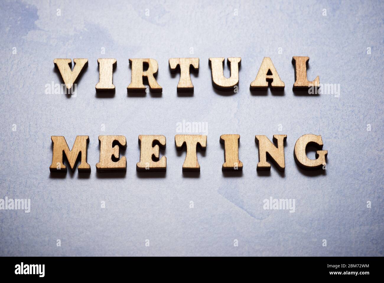 Virtual meeting text in a colored paper Stock Photo - Alamy