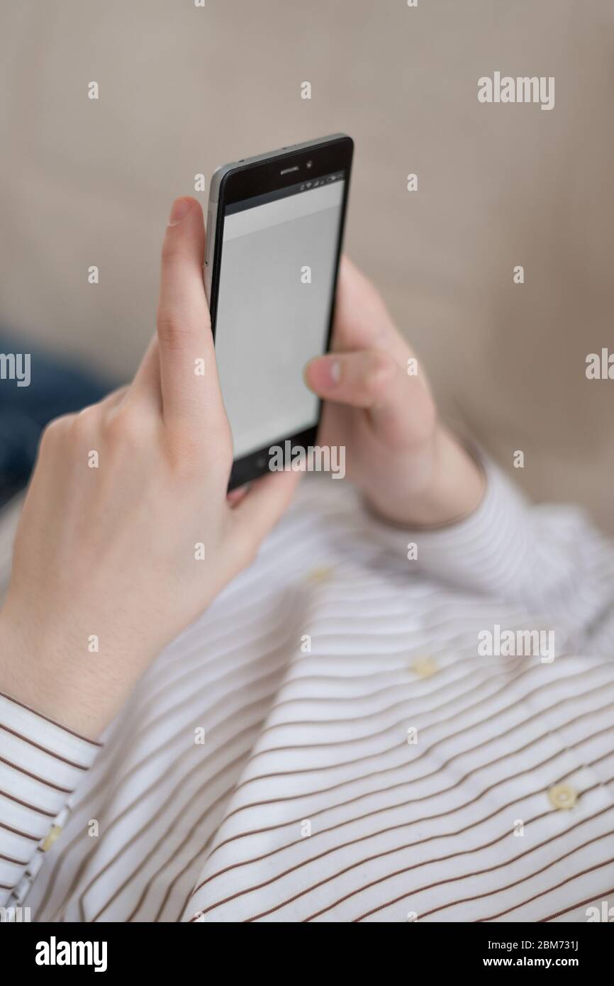 Smartphone in the hands of boy Stock Photo - Alamy