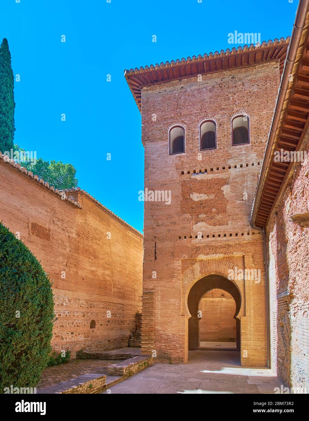 The medieval brick tower of Nasrid palace with horseshoe-shaped gateway ...