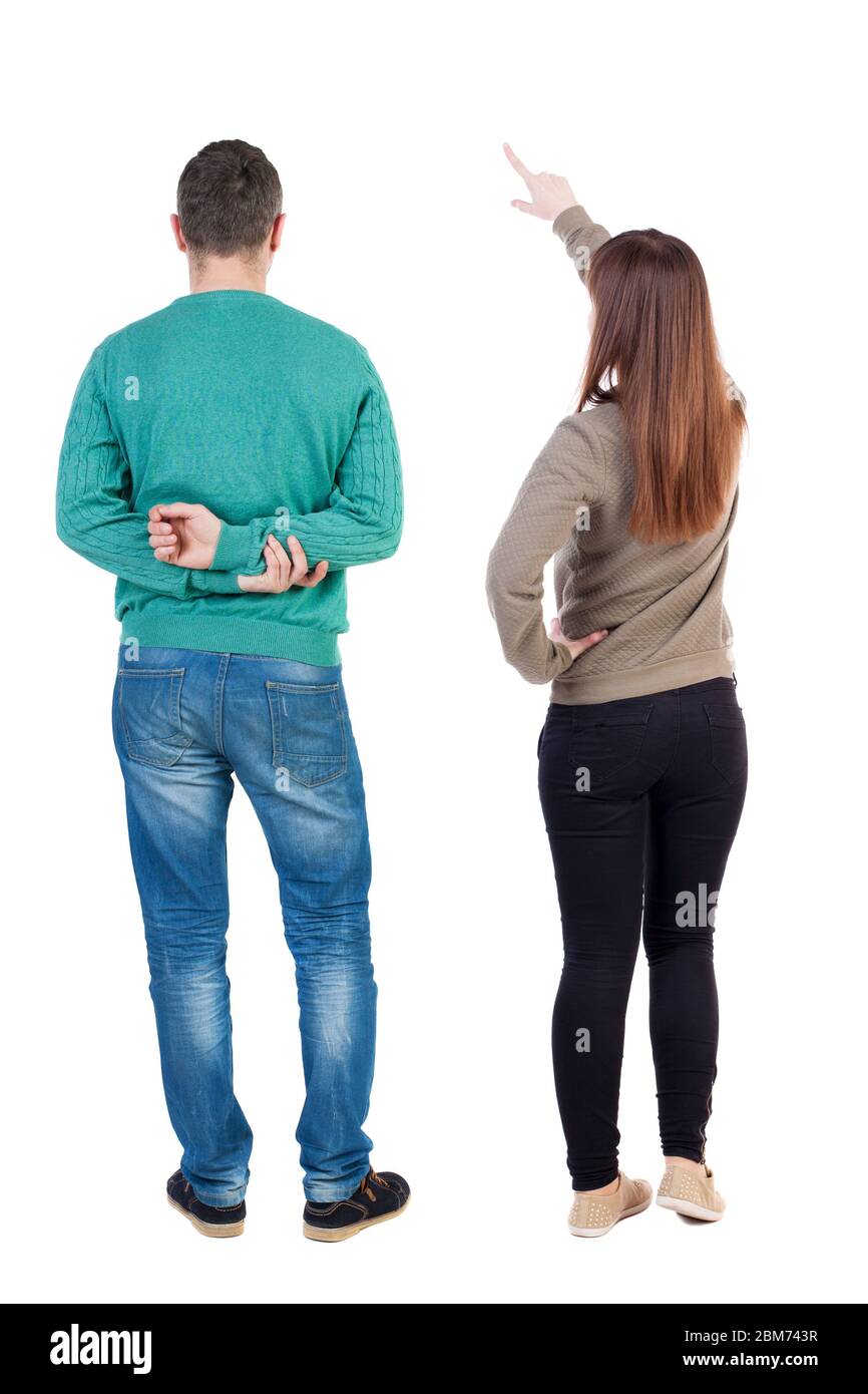 Back view of couple in sweater pointing. Rear view people collection ...