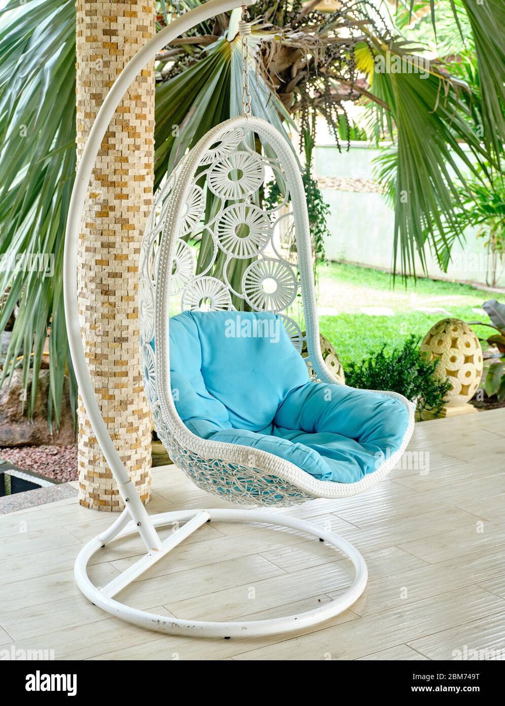 White swing with blue cushion Stock Photo - Alamy