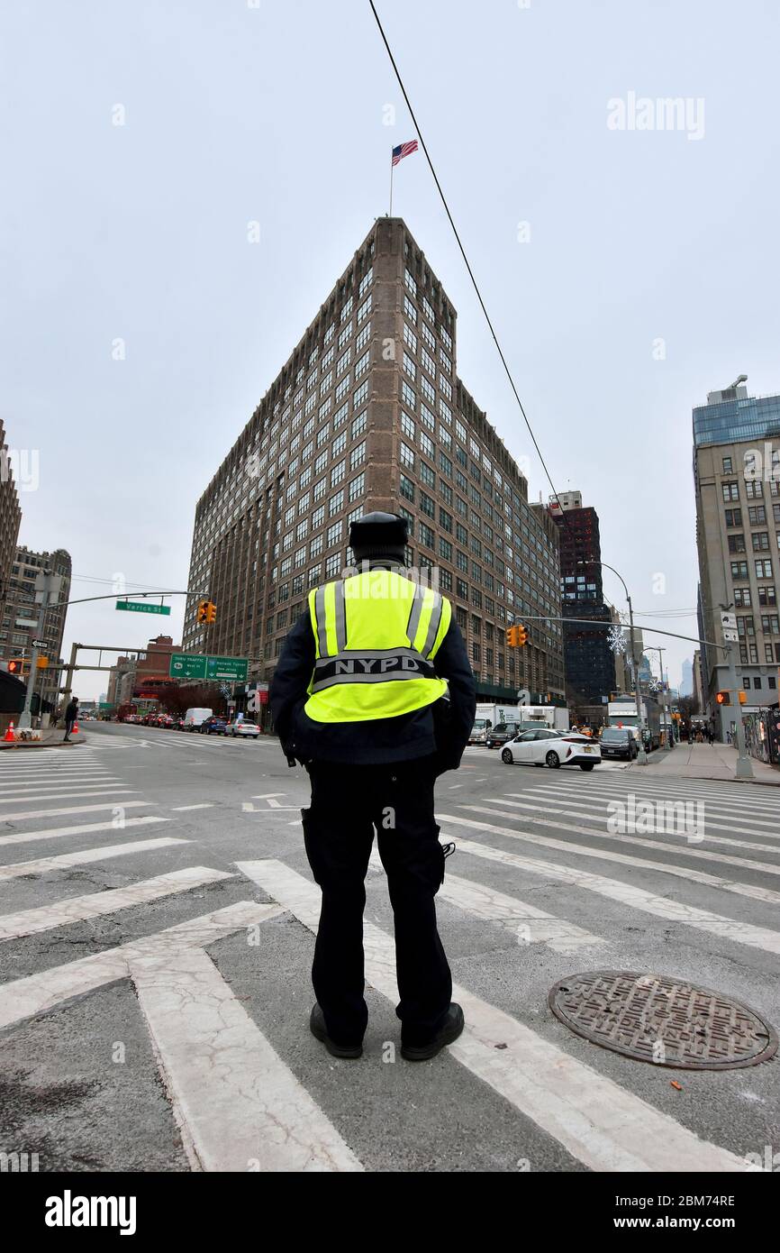Policeman at work. In front is 75 Varick Street Office Space building ...