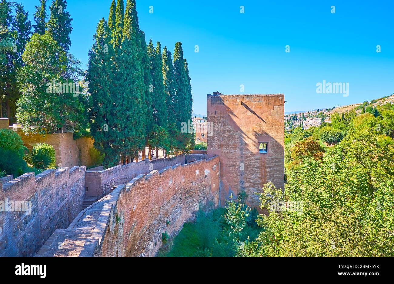 The medieval brick wall and Tower of Captive of Alhambra fortress is ...