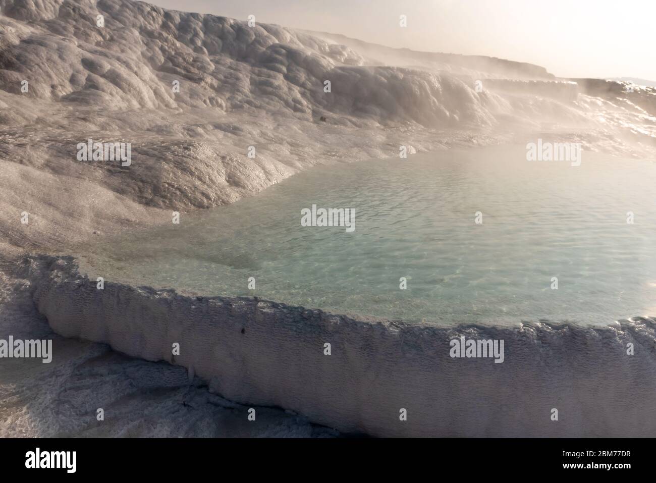 Blue steamy water of the spring in limestone pools in Pamukkale, Turkey ...