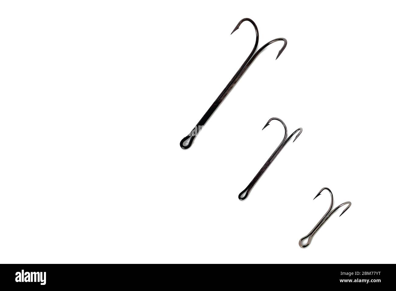 Three, double hooks of different sizes white background close-up Stock ...