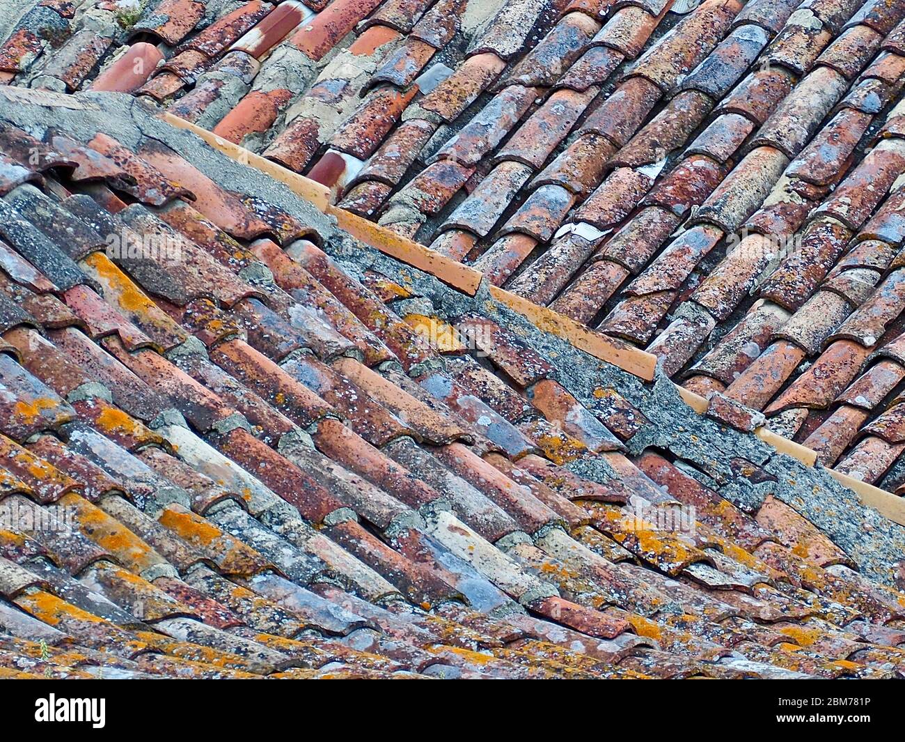 Old roof with colorful roof tiles Stock Photo - Alamy