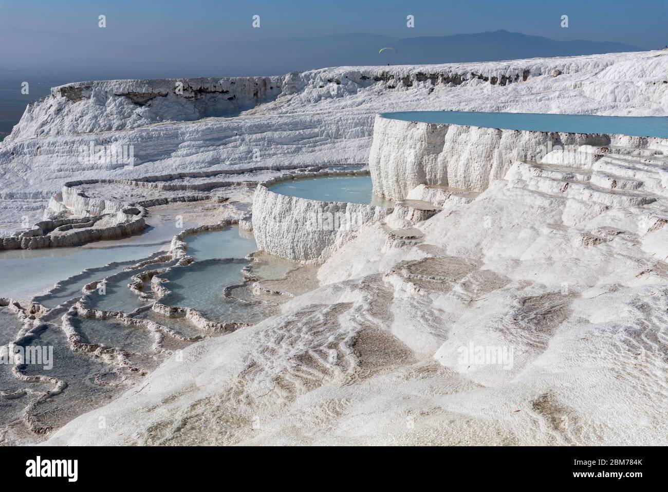 Blue steamy water of the spring in limestone pools in Pamukkale, Turkey ...