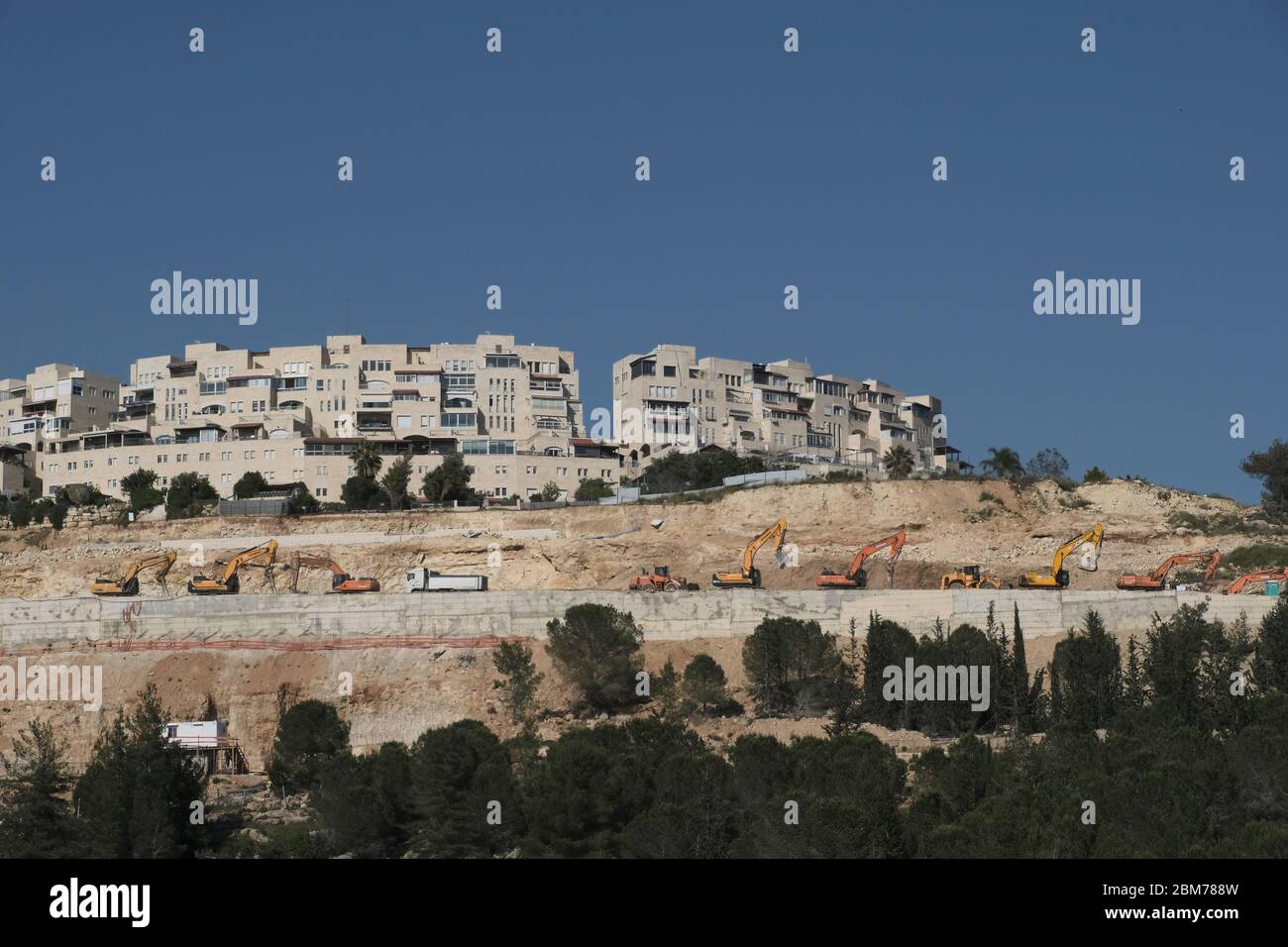 Bulldozers digs lined at the foothill of Malha neighbourhood which was ...