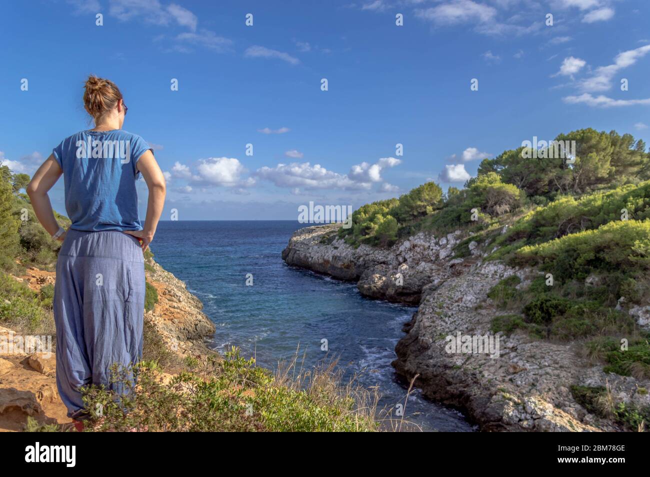 A girl surprised by the beauty of the landscape in Cala Murta , Palma ...