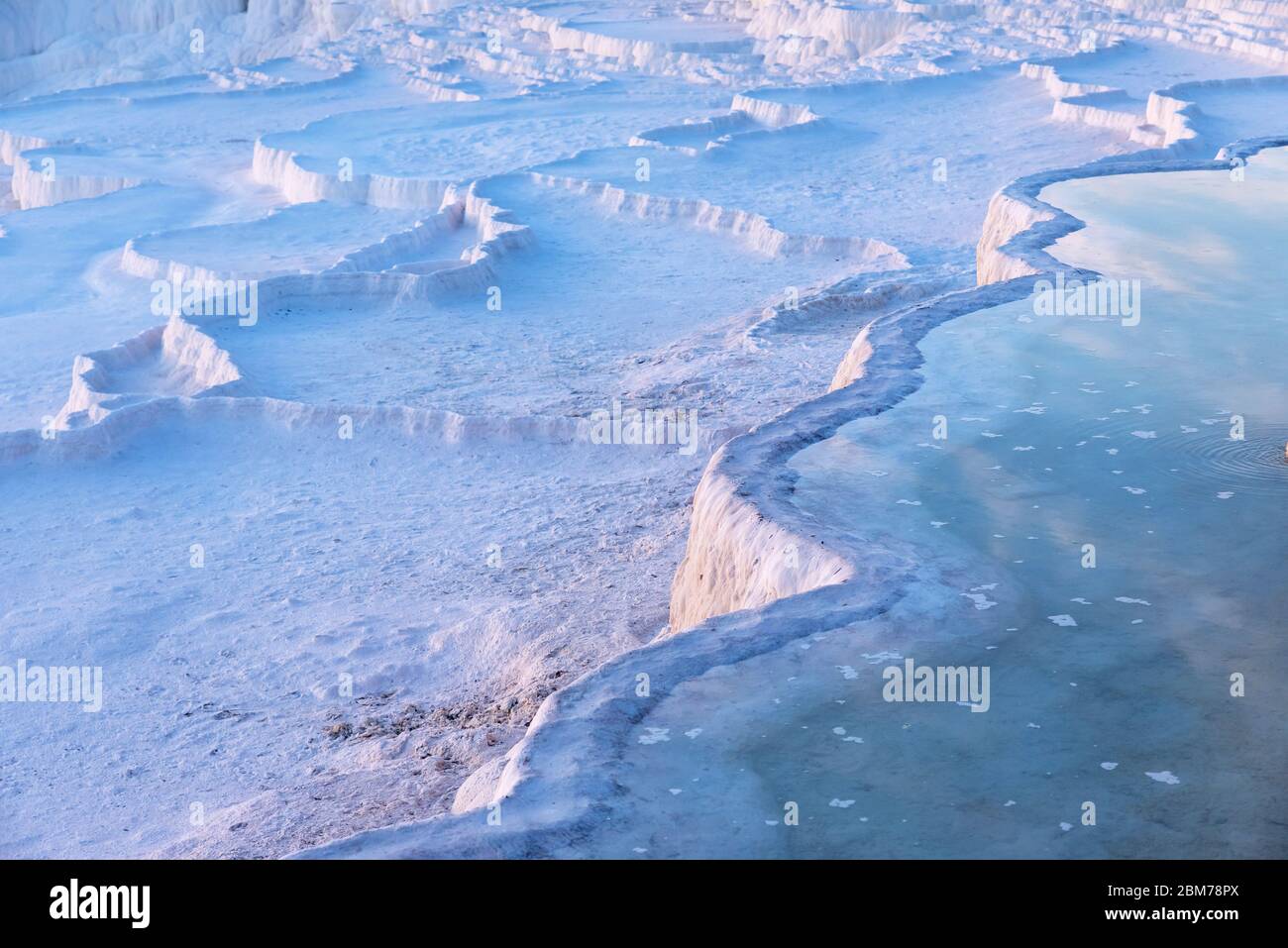 Blue steamy water of the spring in limestone pools in Pamukkale, Turkey ...