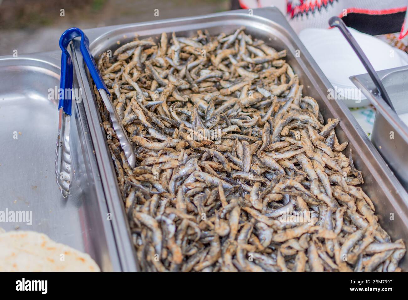 Fried little fish in market or food festival, food truck, asian market ...