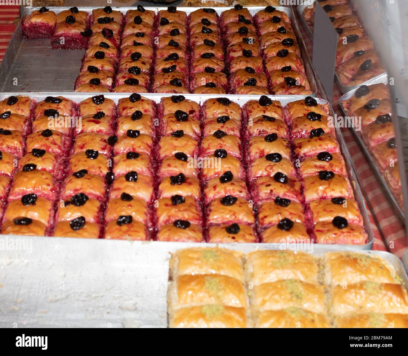 Tray in the showcase with turkish traditional dessert, baklava, cataif ...