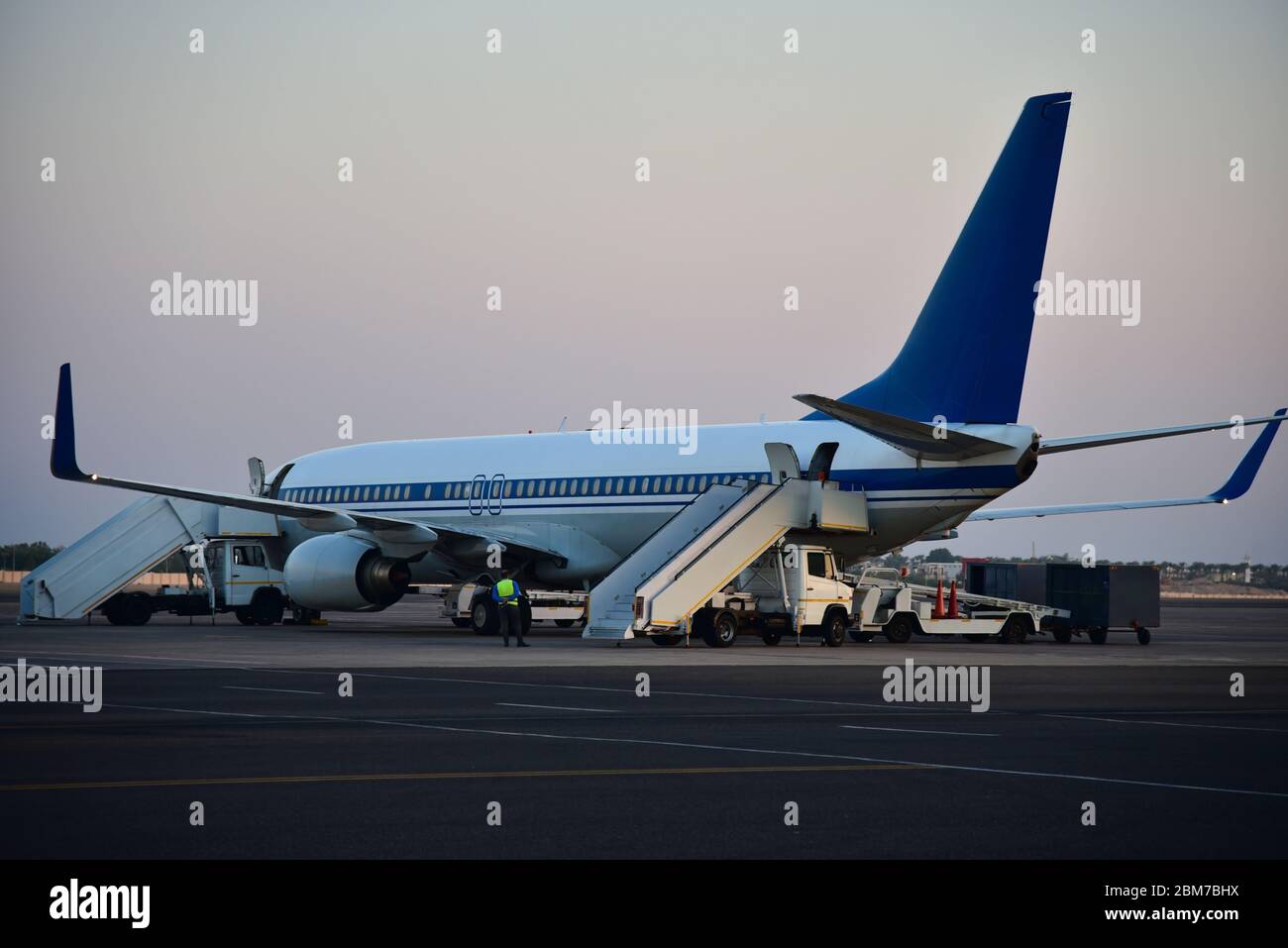 Aircraft service before departure at the airport Stock Photo - Alamy