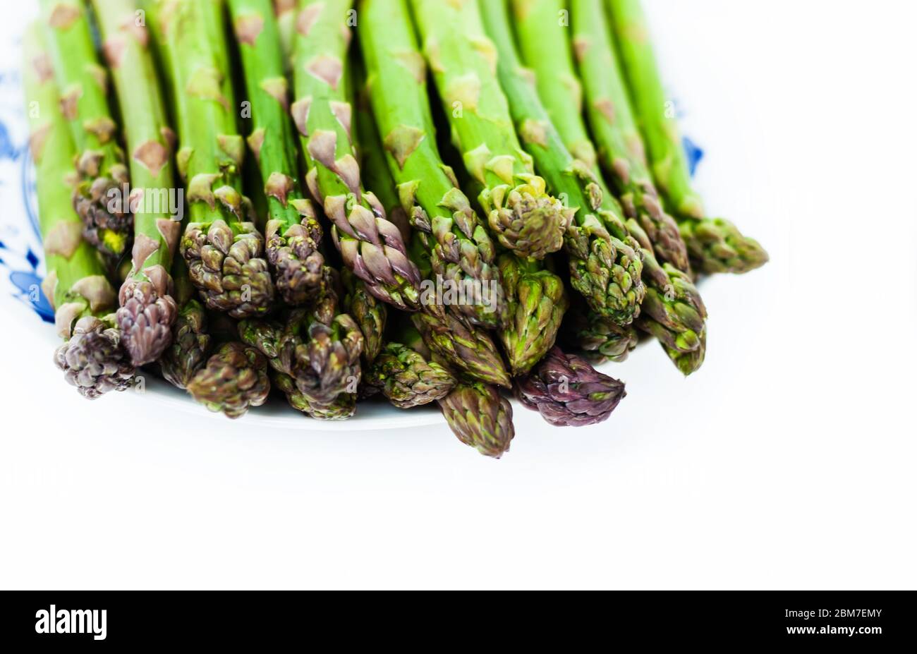 Bunch of fresh raw asparagus on white background, vegetarian concept ...