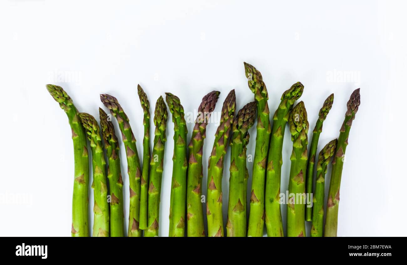 Bunch of fresh raw asparagus on white background, vegetarian concept ...