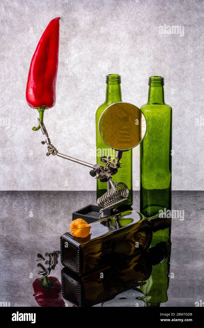 Still life with red pepper and glass bottles Stock Photo - Alamy