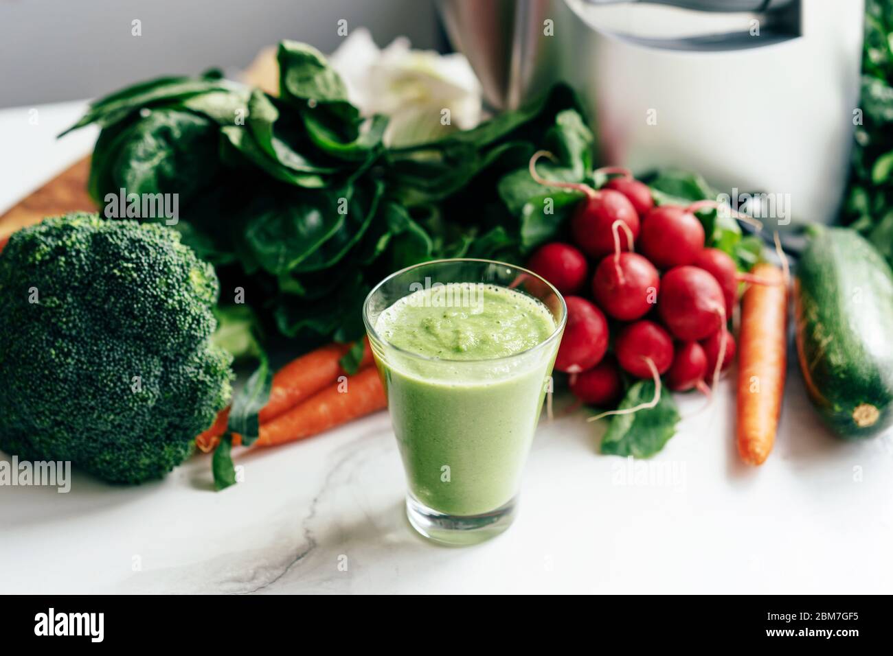 .Ready green smoothie of spinach and vegetables in a glass on the table ...