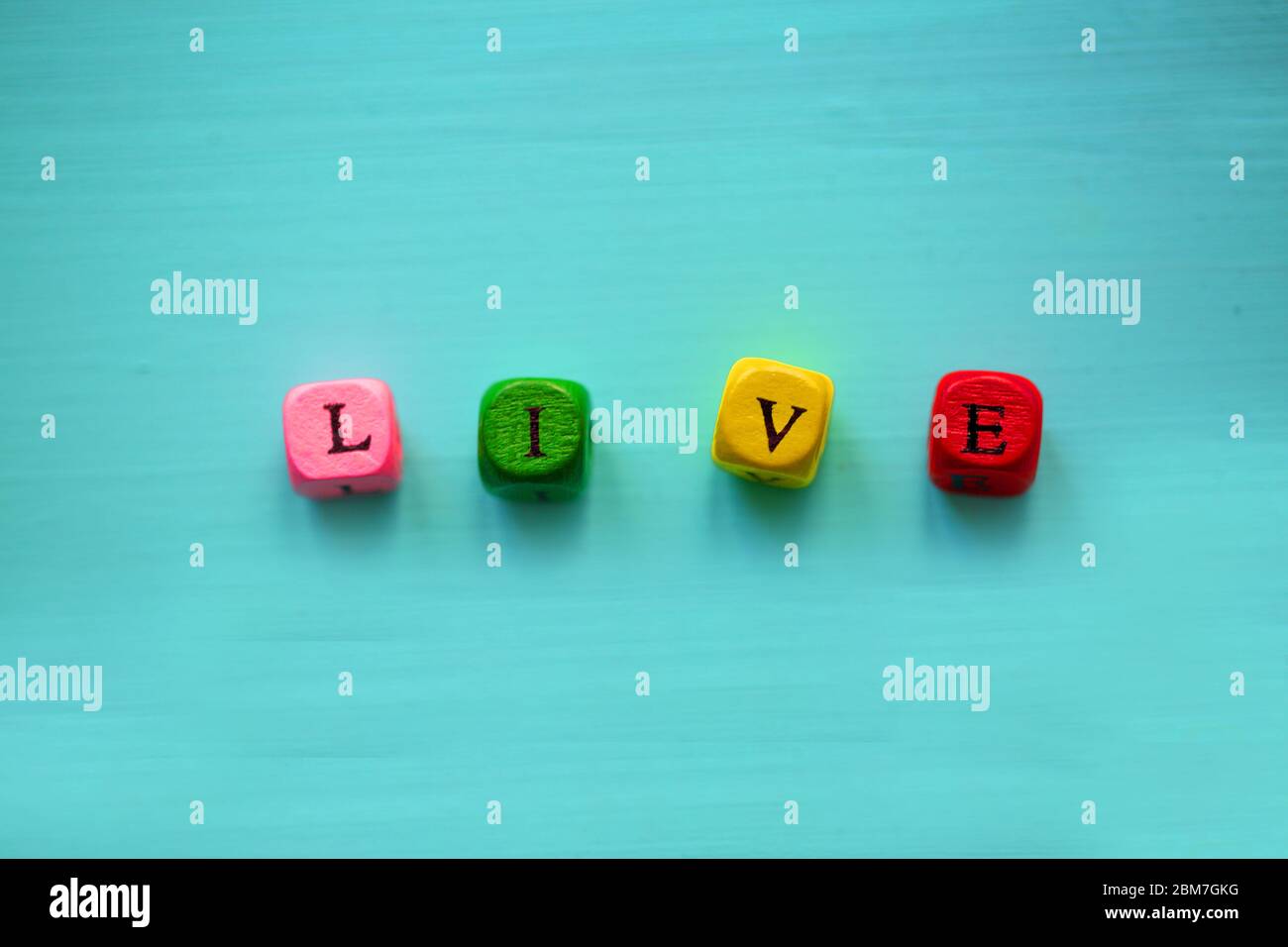 Word live with dices on colorful background, conceptual Stock Photo - Alamy