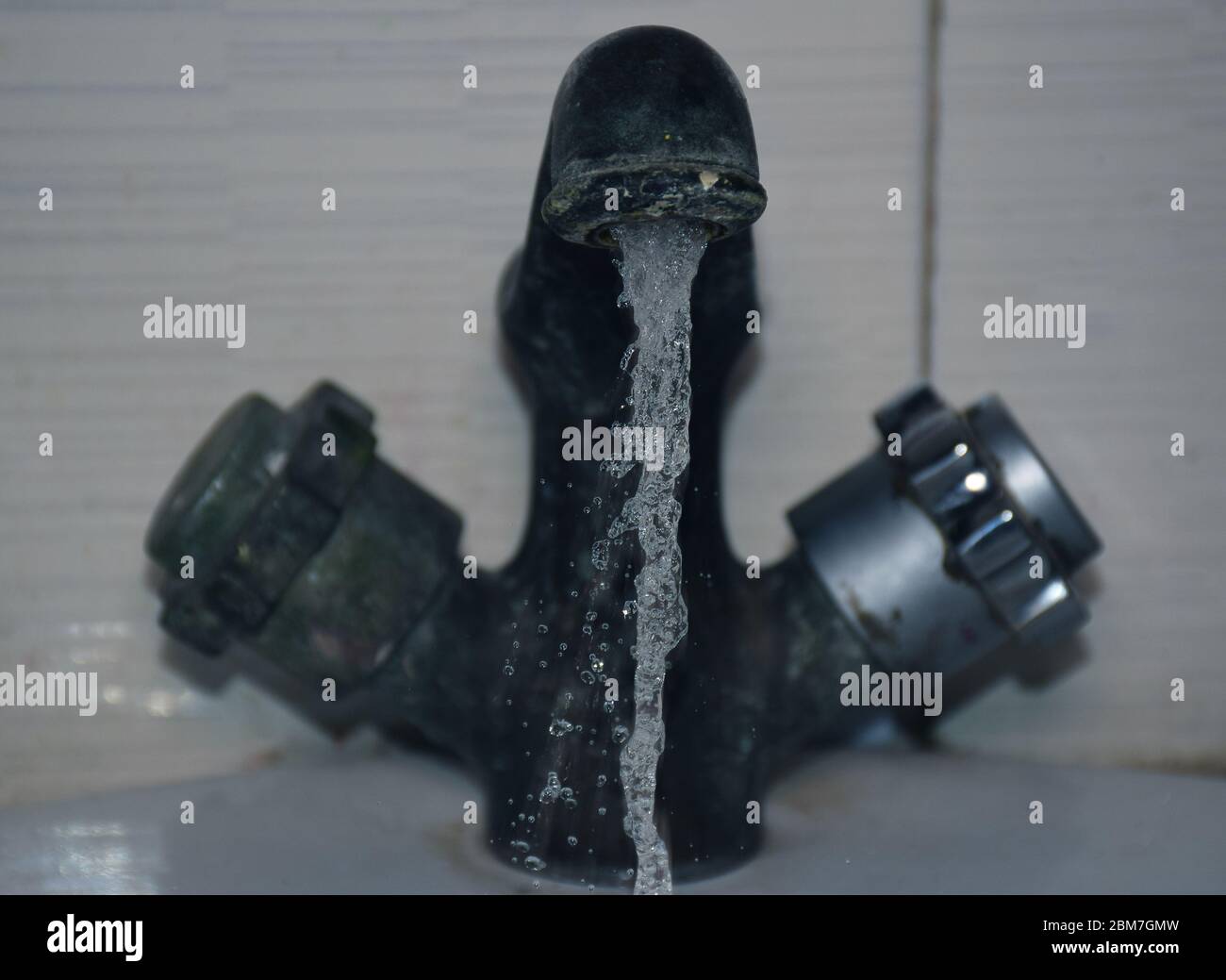 Water Wastage or Water flowing freely from tap Stock Photo - Alamy