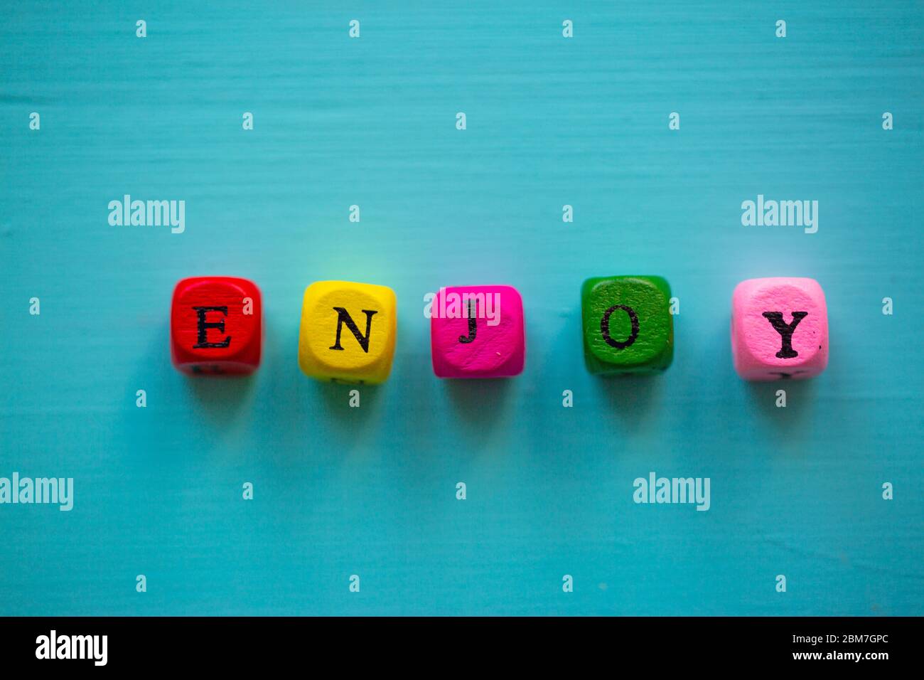 Word enjoy with dices on colorful background, conceptual Stock Photo ...