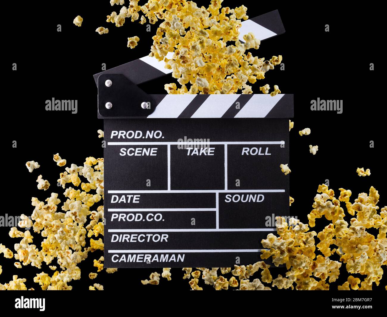 Flying popcorn and film clapper board isolated on black background ...