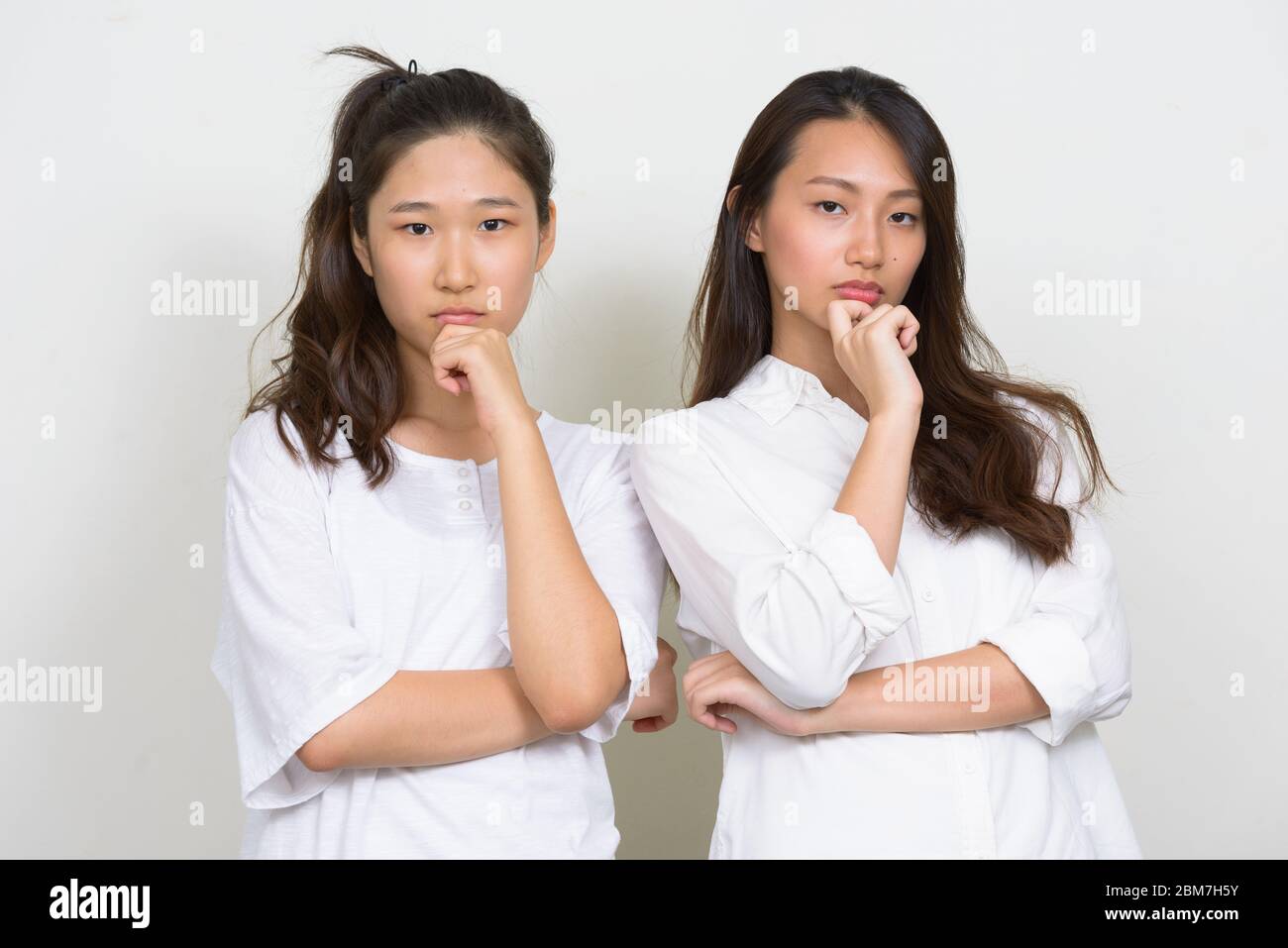 Two young beautiful Asian women as friends thinking together Stock ...