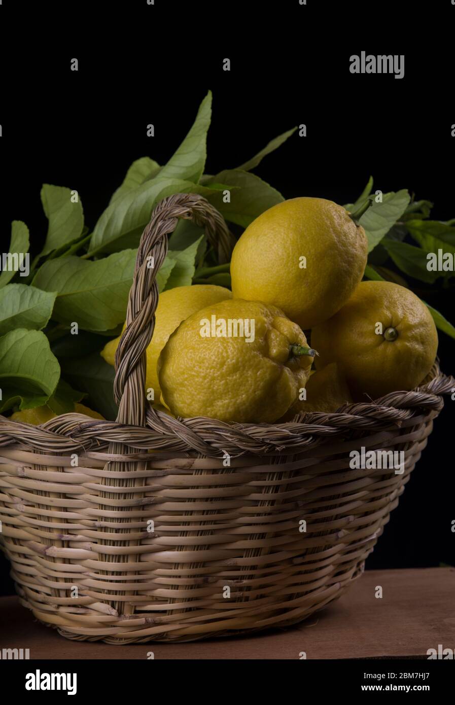 ripe organic lemons on cane basket Stock Photo - Alamy