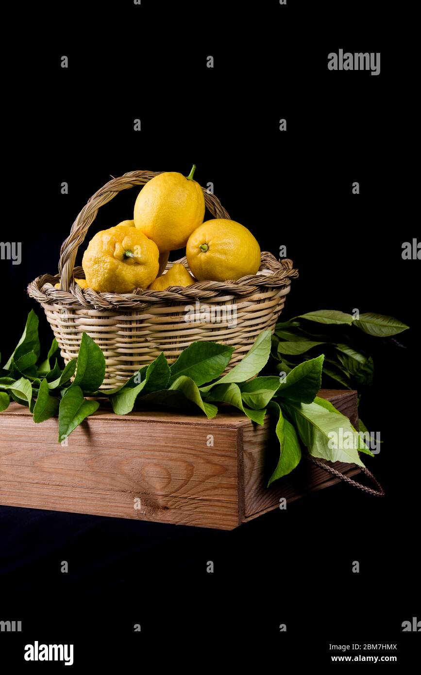 ripe organic lemons on cane basket Stock Photo - Alamy