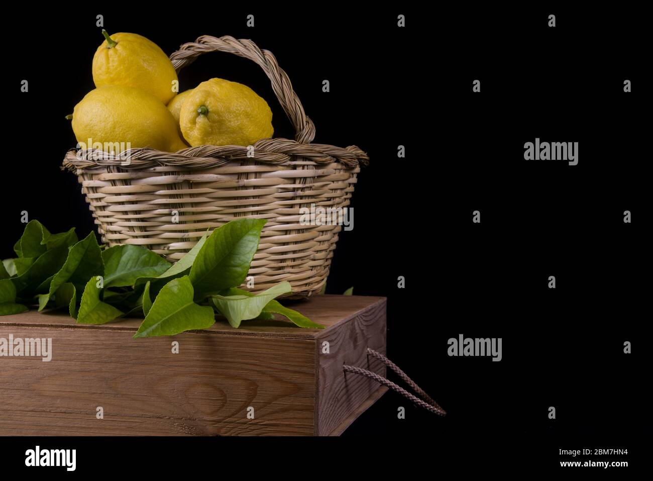 ripe organic lemons on cane basket Stock Photo - Alamy