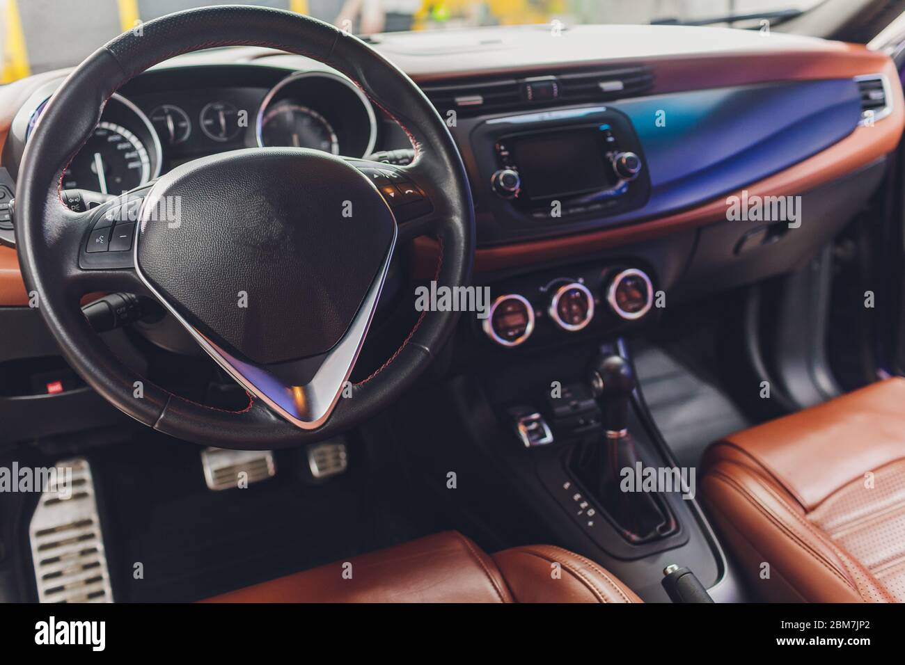 Dark luxury car Interior - steering wheel, shift lever and dashboard ...