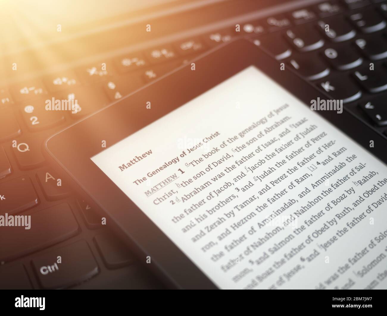 Close up of ebook reader with The Holy Bible on a laptop keyboard, with ...