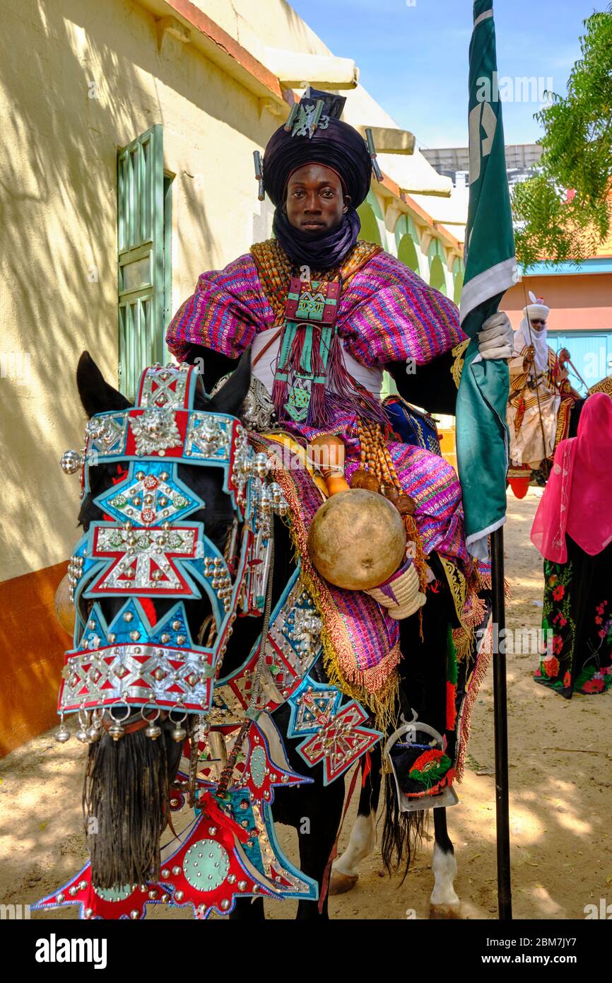 Nobleman rider dressed in a colourful outfit mounting an embellished ...