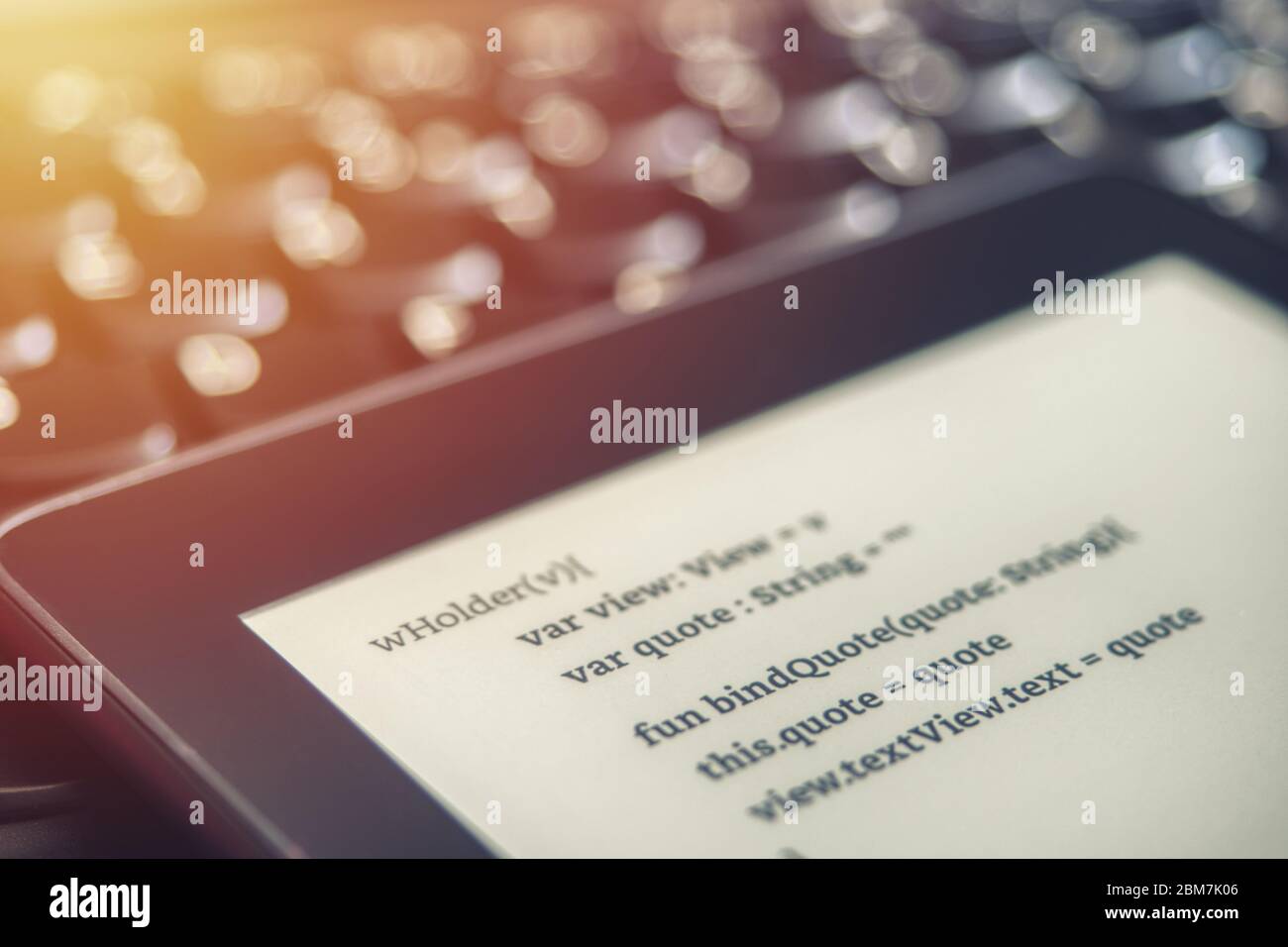 High view of a ebook reader with programing lessons on a laptop ...