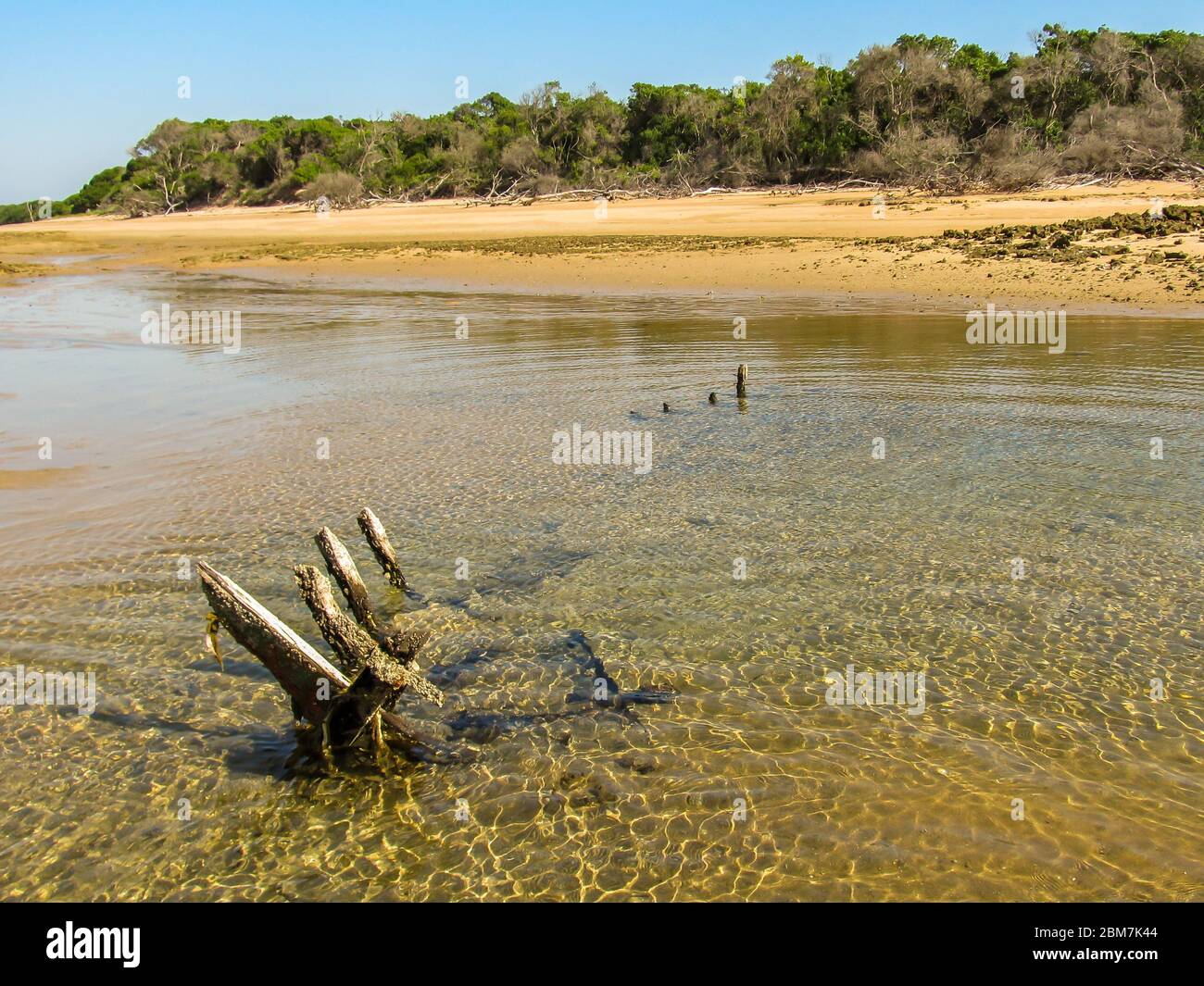 The ribbed remains of a wrecked fishing boat in the shallow water at ...