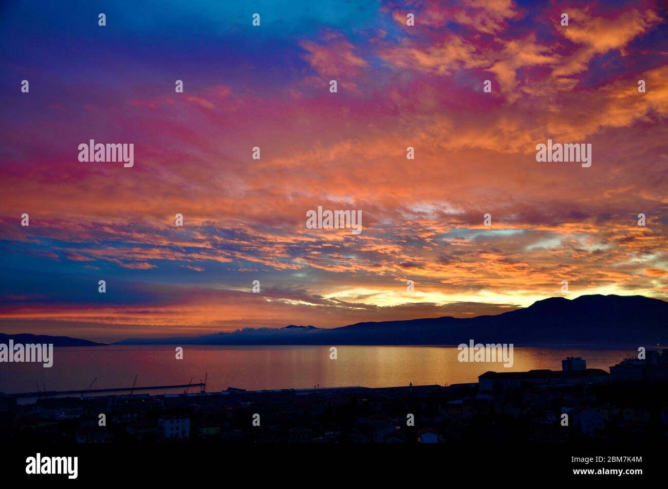 Beautiful golden sky and sunset above Mountain Učka and Adriatic Sea in ...