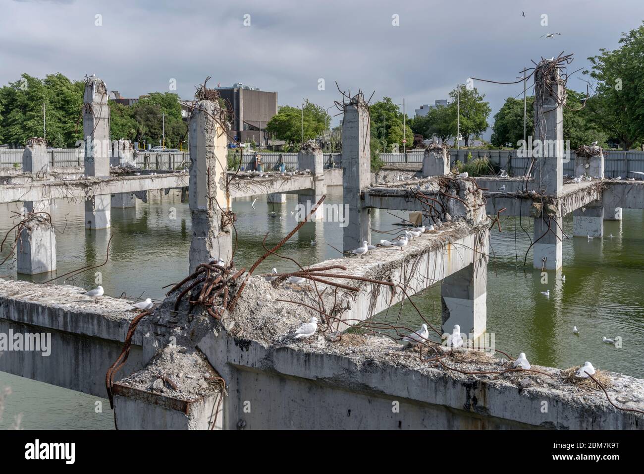 cityscape with flooded ruins of collapsed concrete building with Black ...