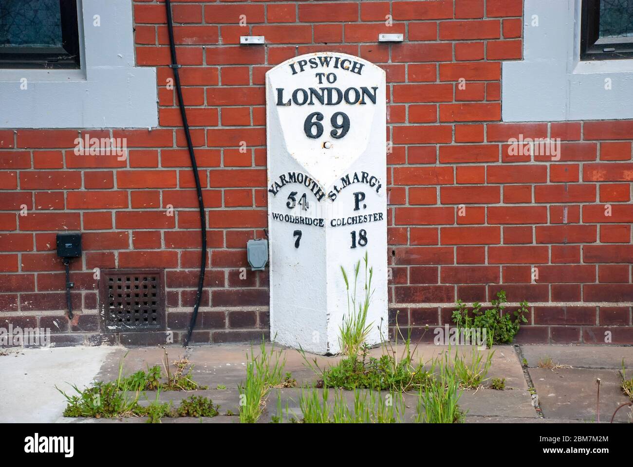 An old milestone marker in showing the distance to London from Ipswich ...