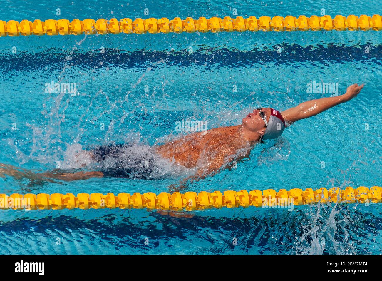 Aaron Peirsol (USA) competing in the Men's 100m backstroke heats. 2004 ...