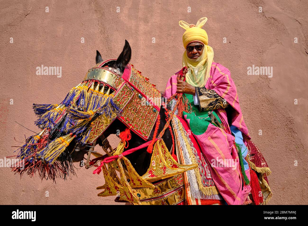 Nobleman rider dressed in a colourful outfit mounting an embellished ...