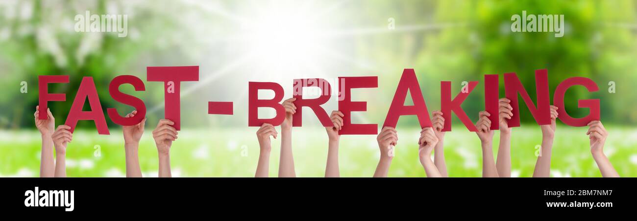 People Hands Holding Word Fast-Breaking, Grass Meadow Stock Photo - Alamy