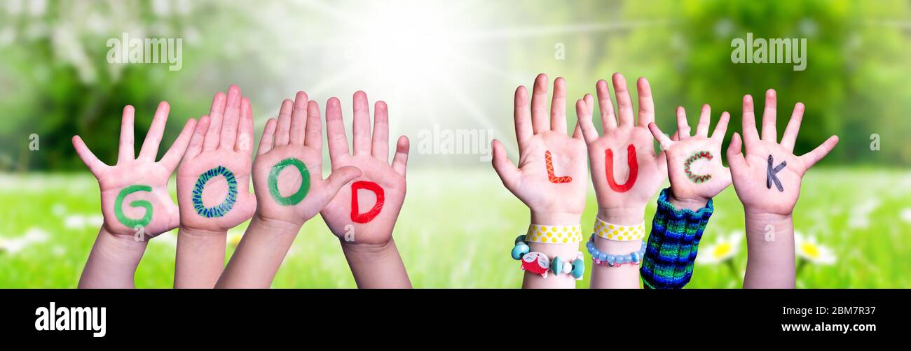 Kids Hands Holding Word Good Luck, Grass Meadow Stock Photo - Alamy