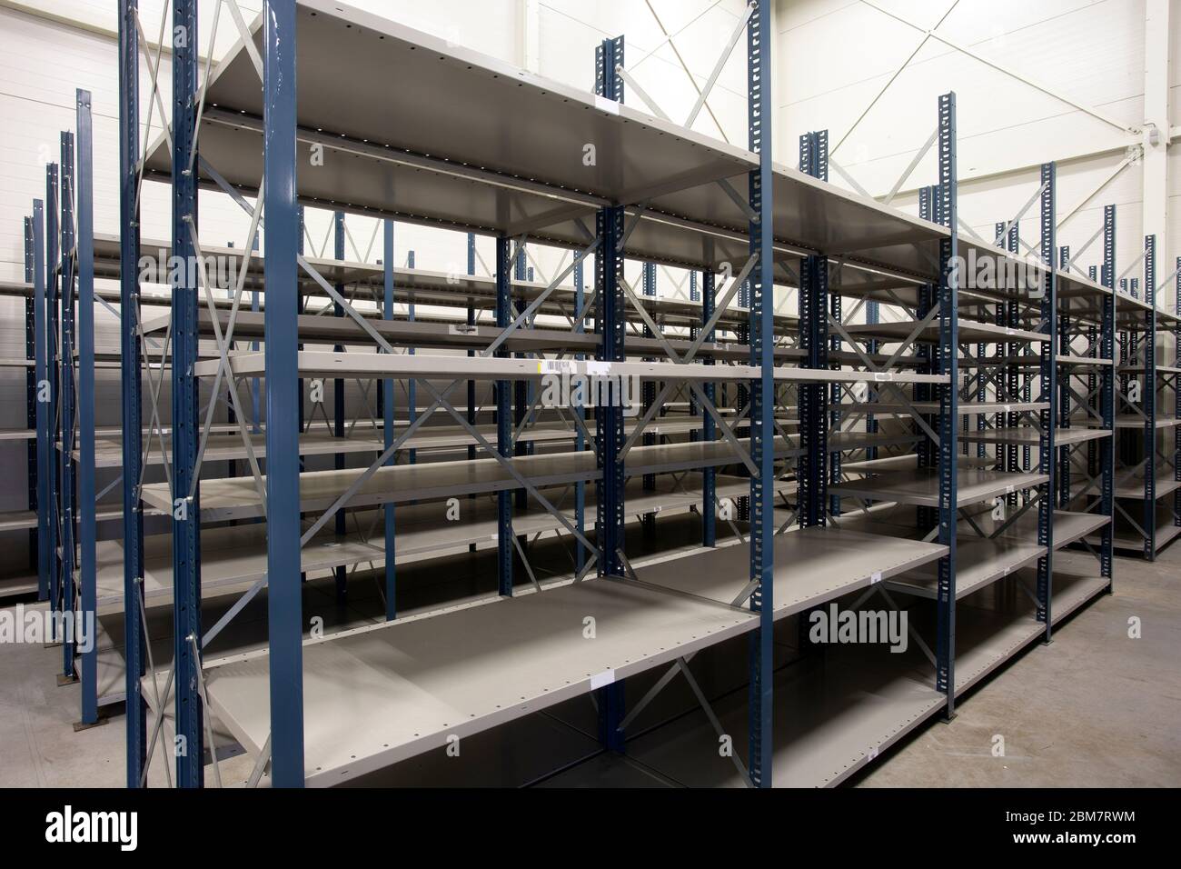 huge warehouse with empty racks inside for storage modern design, metal ...