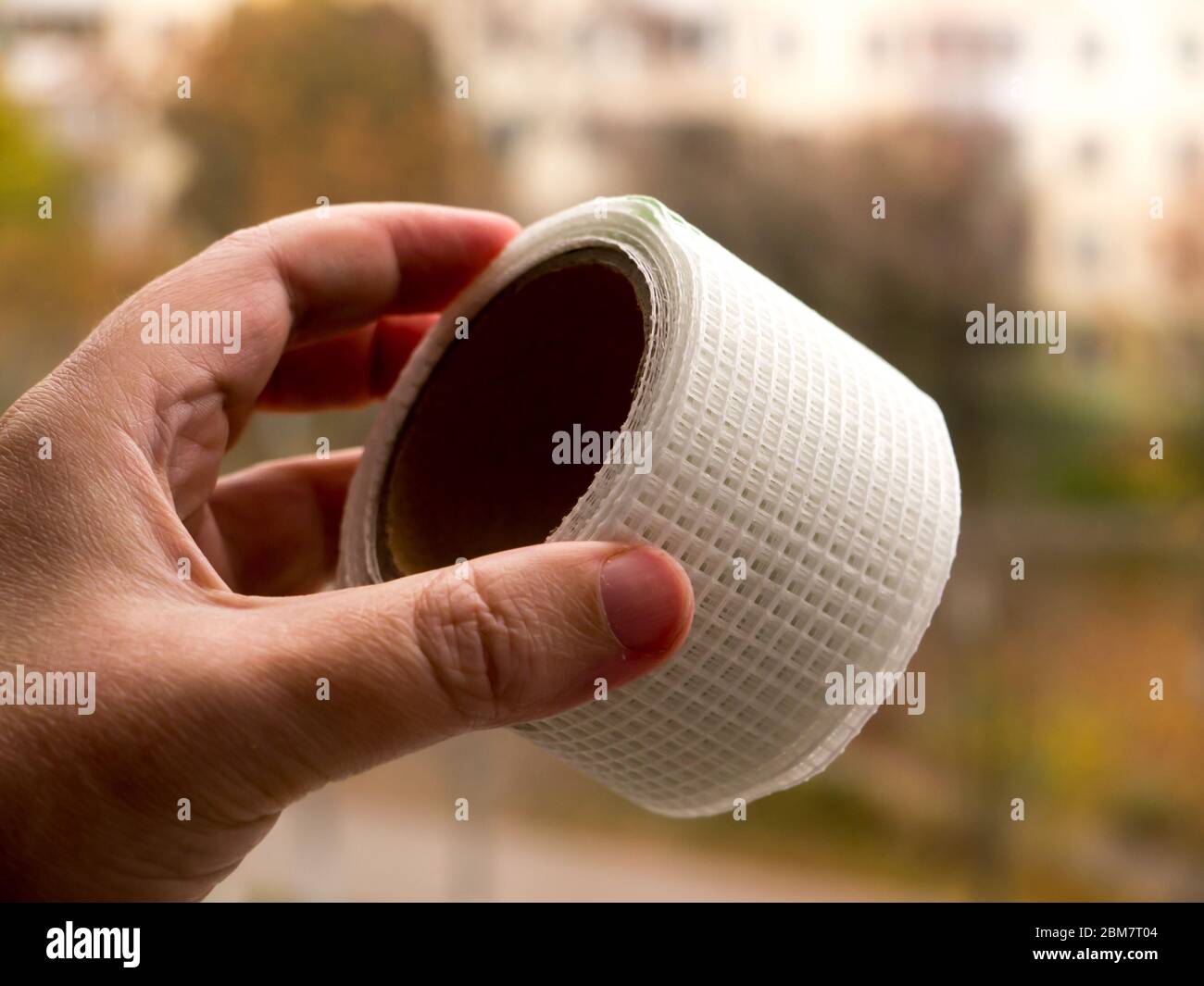 The Sticky yellow mesh tape Stock Photo - Alamy