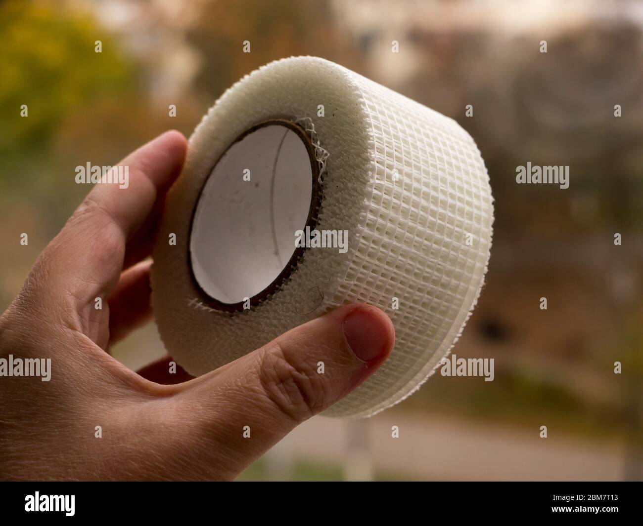 The Sticky yellow mesh tape Stock Photo - Alamy