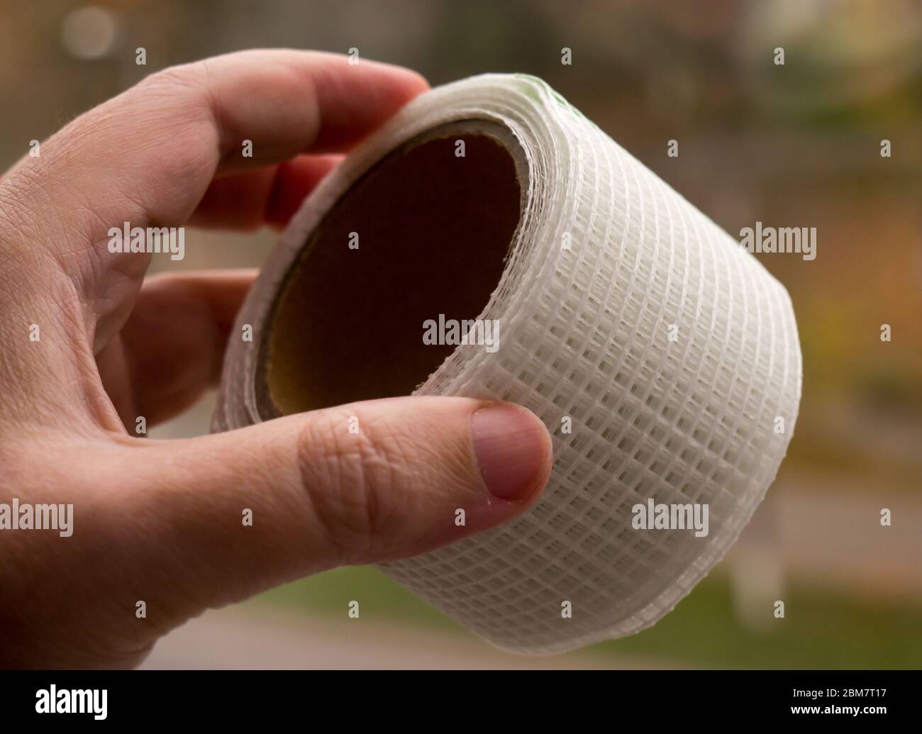 The Sticky yellow mesh tape Stock Photo - Alamy