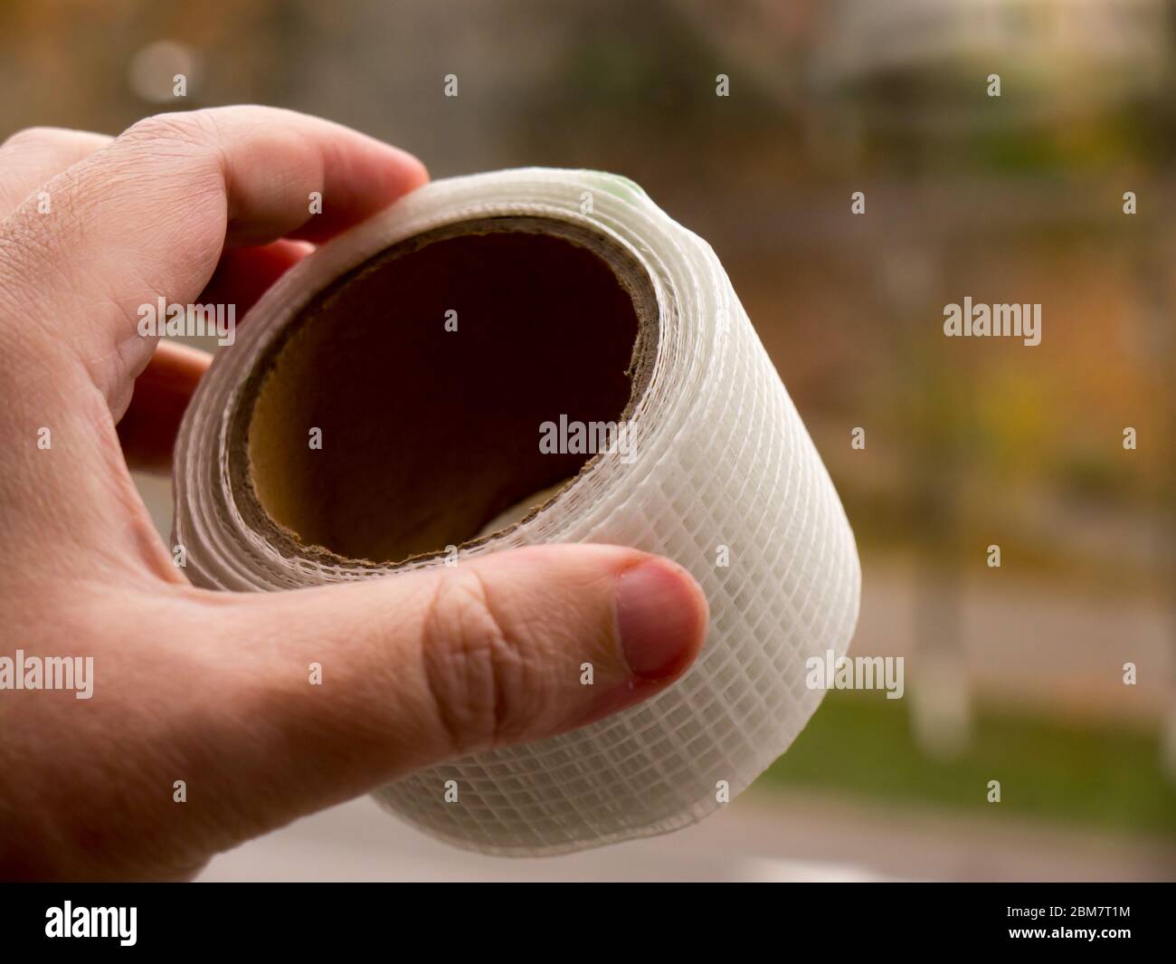 The Sticky yellow mesh tape Stock Photo - Alamy