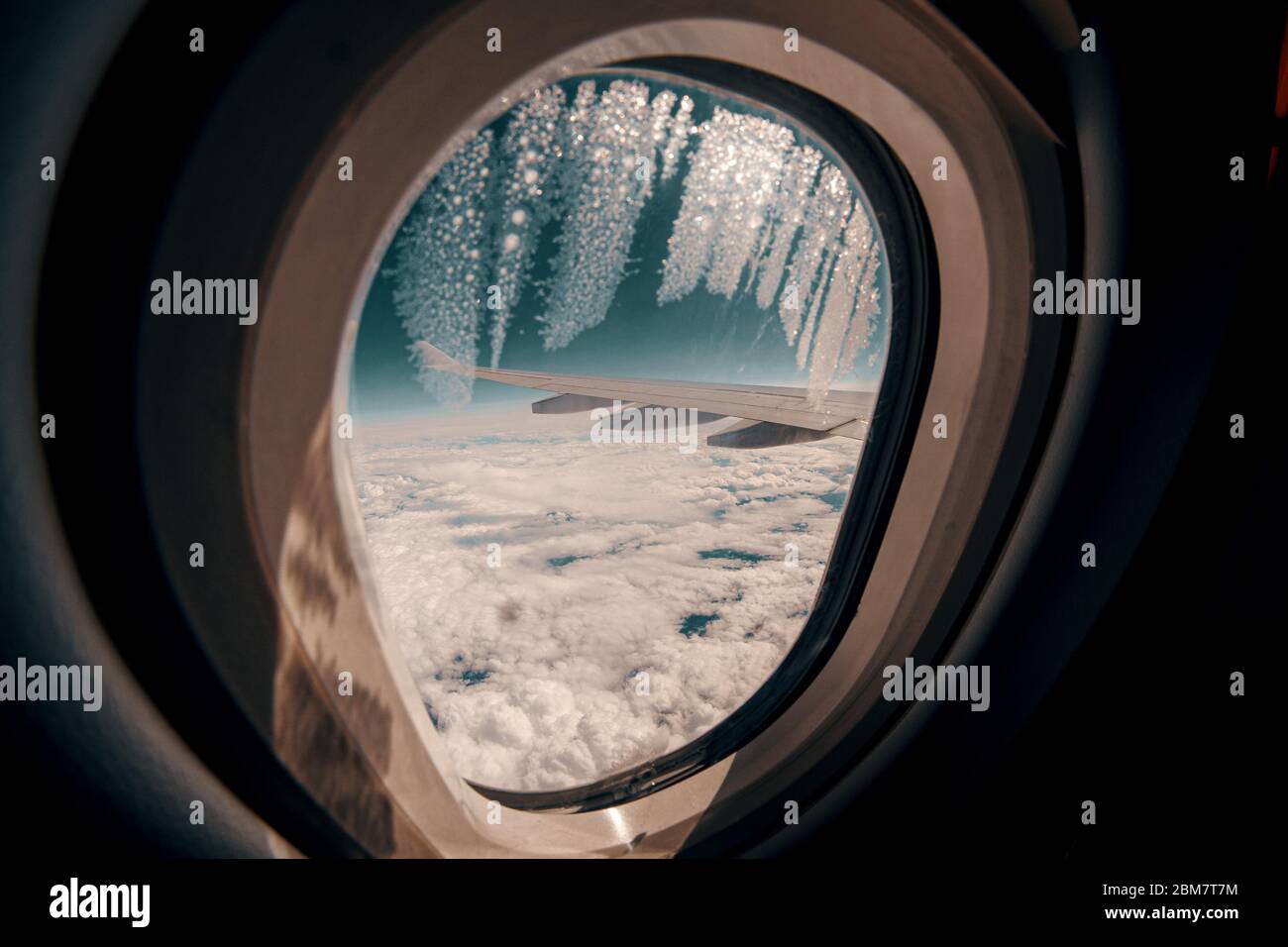 frosty window on an airplane over the clouds Stock Photo - Alamy