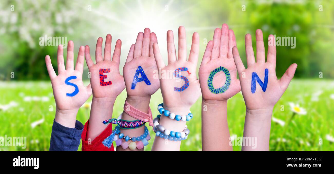 Children Hands Building Word Season, Grass Meadow Stock Photo - Alamy