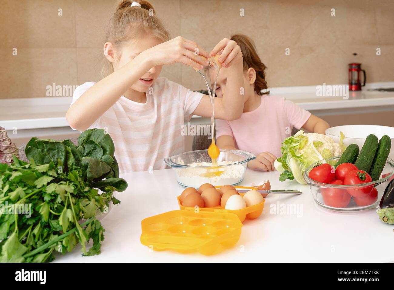 happy family funny kids are preparing the dough, bake cookies in the ...