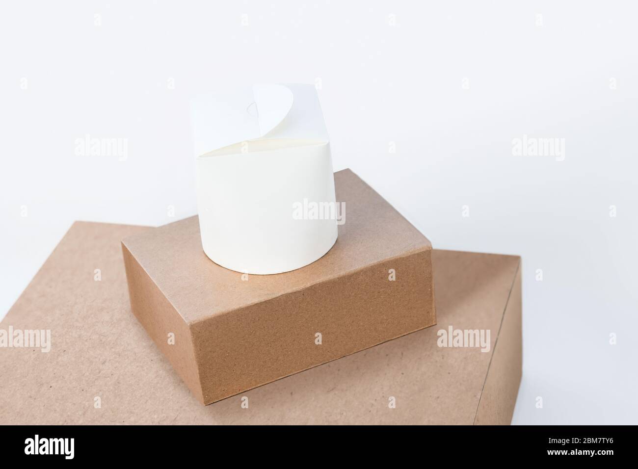 Close up picture of several brown boxes and a white box Stock Photo - Alamy